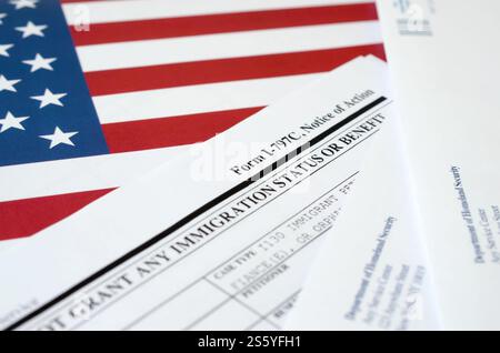 I-797c Notice of action blank form lies on United States flag with blue ...