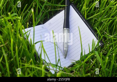 Note book with black pages with a pen Stock Photo - Alamy