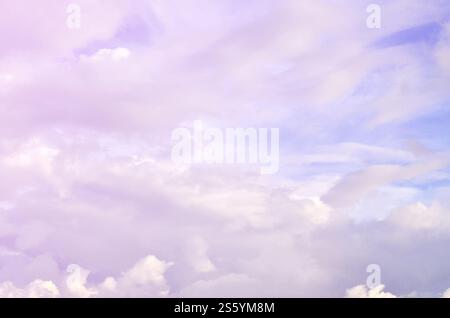 A blue cloudy sky with many small clouds blocking the sun Stock Photo ...