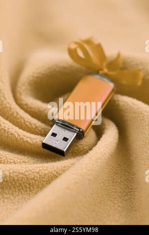 Usb flash memory card with bow lies on a blanket of soft and furry ...