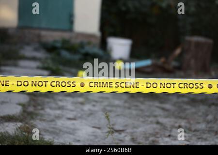 Crime scene tape for covering the area cordon. Yellow tape with blurred ...
