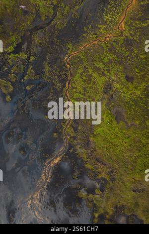 Aerial view of striking volcanic patterns and sediment-rich waters in ...