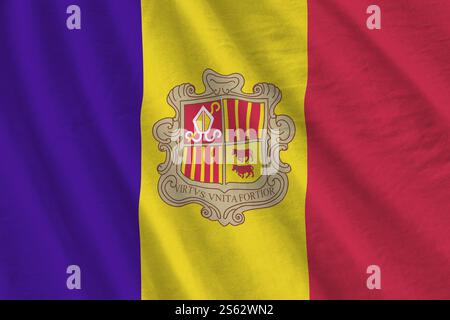 Andorra flag with big folds waving close up under the studio light ...