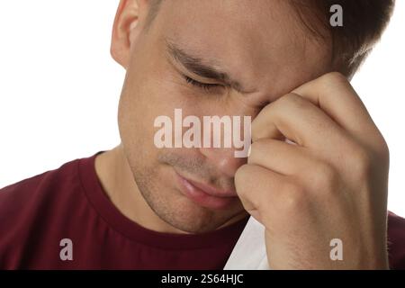 Crying man wiping tears with tissue on white background Stock Photo - Alamy
