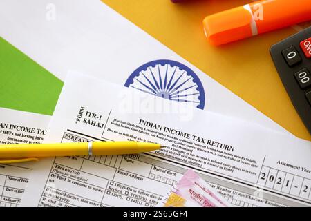 Indian income tax return blank form with pen and indian rupees bills on ...
