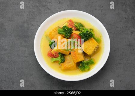 Salmon Kuah Kuning, fish soup with broccoli and tomatoes. Indonesian ...
