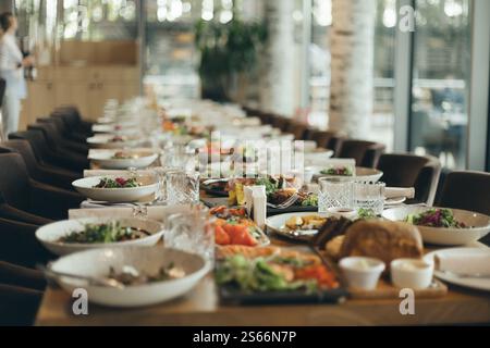 dishes on banquet tables, serving glasses, spoons and plates in ...