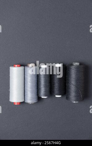 Colourful thread spools on a black background Stock Photo - Alamy