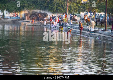 Hindu Pilgrims perform morning ablutions at a pond in front of Janaki ...