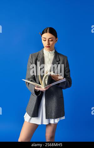 A young woman in a blazer reading a magazine. stress-free concept ...
