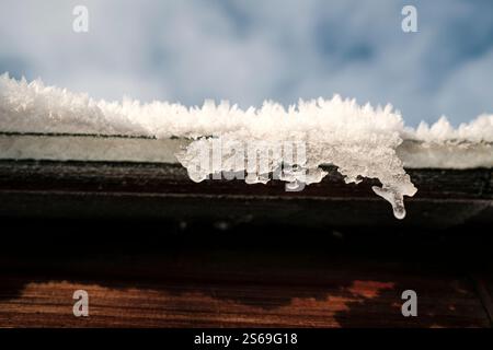Snow and ice slipping off a greenhouse roof Stock Photo - Alamy