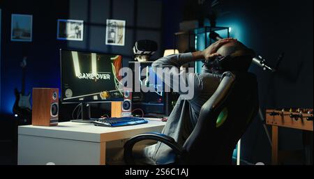 Man frustrated after receiving game over message on computer display ...
