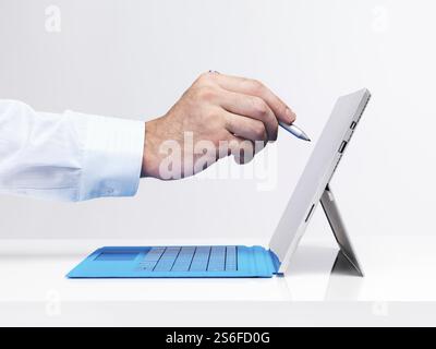 Closeup man hand touches white plaster wall with sunset light, shallow ...