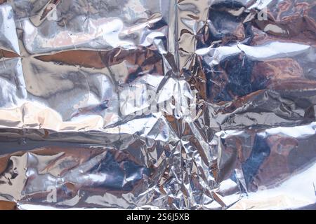 Crumpled reflective shiny gift wrapping material texture background ...