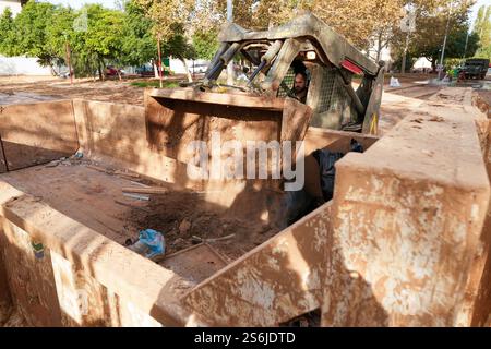 Mini excavator bobcat driver operator transporting debris to a big ...