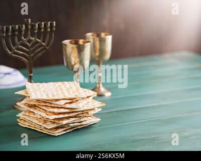 Passover Seder plate with wine and matza on table against color wooden ...