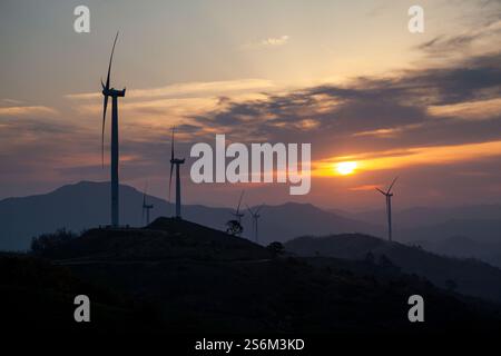 Sunrise over green pastures and wind farms along the mountain Stock ...