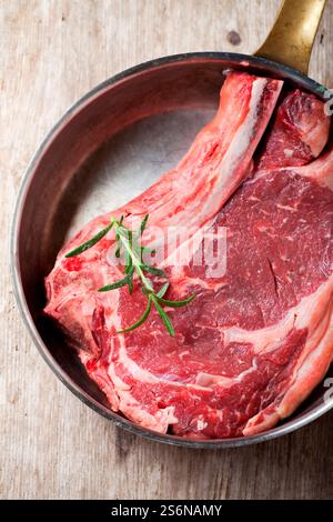 raw t bone steak in a copper pan Stock Photo - Alamy