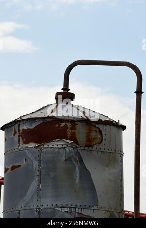 An old, rusty grain storage silo on an open-air platform Stock Photo ...