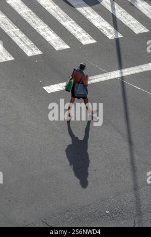 A man walks across an intersection in Tokyo, Friday, April 15, 2022 ...