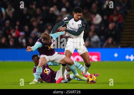Burnley's Zian Flemming (centre) battles for the ball with Queens Park ...