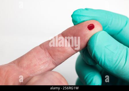 Drop of blood from the fingertip, small blood sample, capillary blood ...