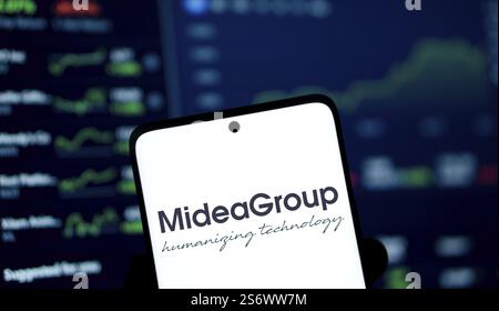 Midea group logo is displayed on smartphone. Midea Group is a Chinese ...
