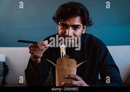 Pakistani guy with traditional outfit eating popcorn Stock Photo - Alamy