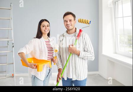 Repair, renovation and people concept - portrait of happy couple pour ...