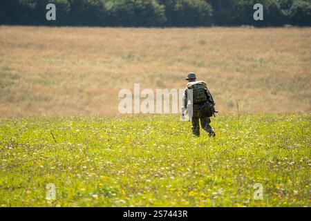 army soldier with gun on a 40kg loaded march tab military exercise ...