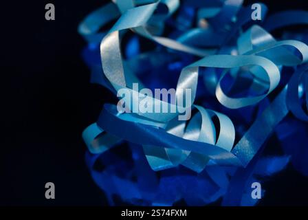Elegant blue ribbons with a glossy finish, placed on a reflective ...