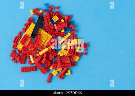 Plastic building blocks on blue background Stock Photo - Alamy