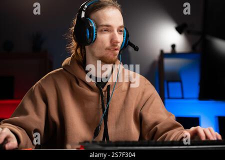 Young caucasian man streamer playing video game with winner expression ...