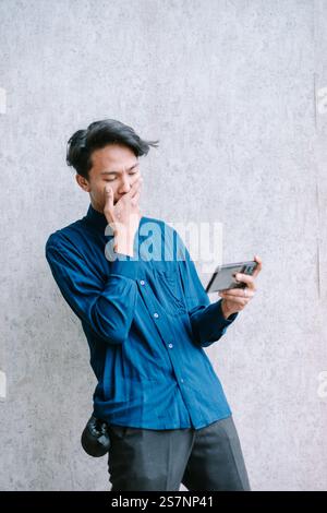 Young man reacting with surprise in a lively group setting Stock Photo ...