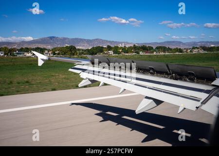 Close-up of an airplane wing with spoilers deployed, showcasing the ...