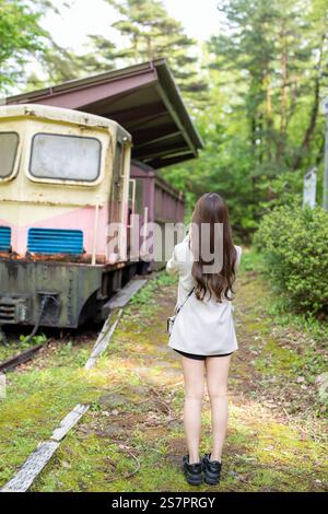 Young Japanese woman on a train platform Stock Photo - Alamy