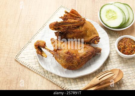 Bebek Goreng, served with chili sauce (sambal) and cucumber. Indonesian ...