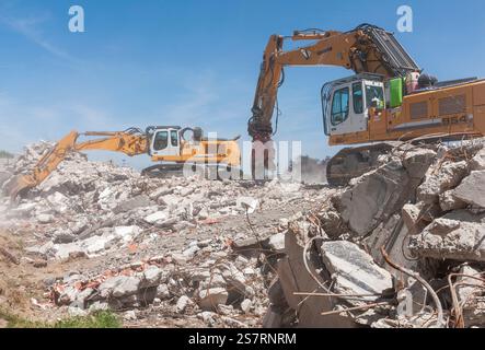 excavator crushing concrete piles Stock Photo - Alamy
