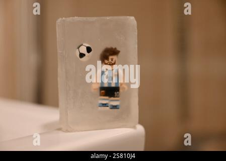 a lego style mini figure of lionel messi encased inside a clear bar of ...