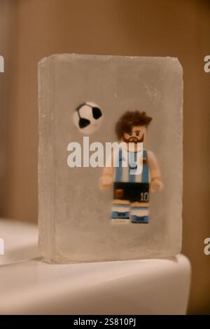 a lego style mini figure of lionel messi encased inside a clear bar of ...