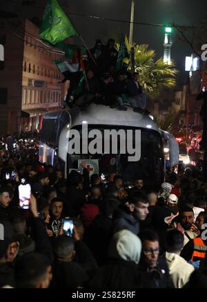 Ramallah. 19th Jan, 2025. People gather around a bus carrying released ...