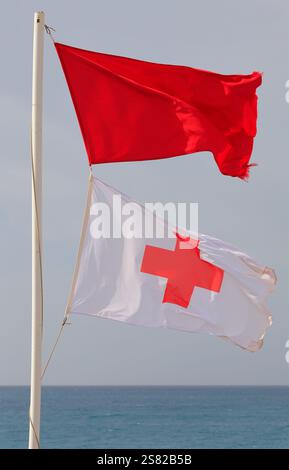 Life guard (cruz roja) flags flying at Piedra Playa beach, El Cotillo ...