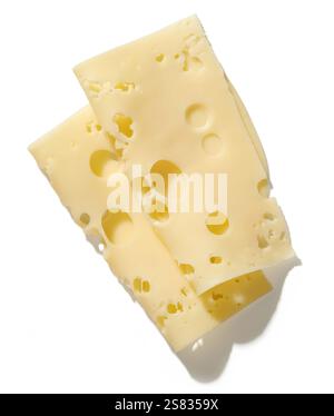 top view of slices of cheese on crumpled paper and ripe red grapes on ...