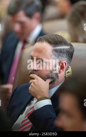 Texas state Rep. Dustin Burrows, right, speaks during a press ...