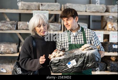 Older woman choosing mycelium in a garden store Stock Photo - Alamy