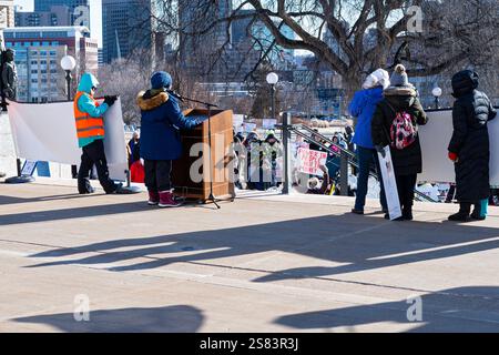 St. Paul, MN - January 18, 2025: Participants behind speakers’ podium ...