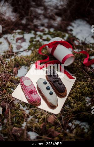 Composition with sweet eclairs and coffee on wooden background with ...