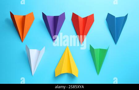 Green paper planes on color background Stock Photo - Alamy