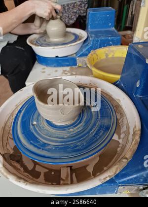 Hands of two artists making clay pots Stock Photo - Alamy