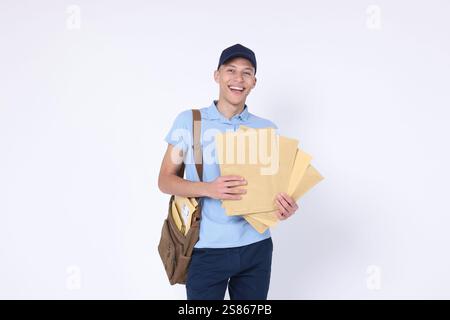 Happy postman with bag and envelopes on white background Stock Photo ...